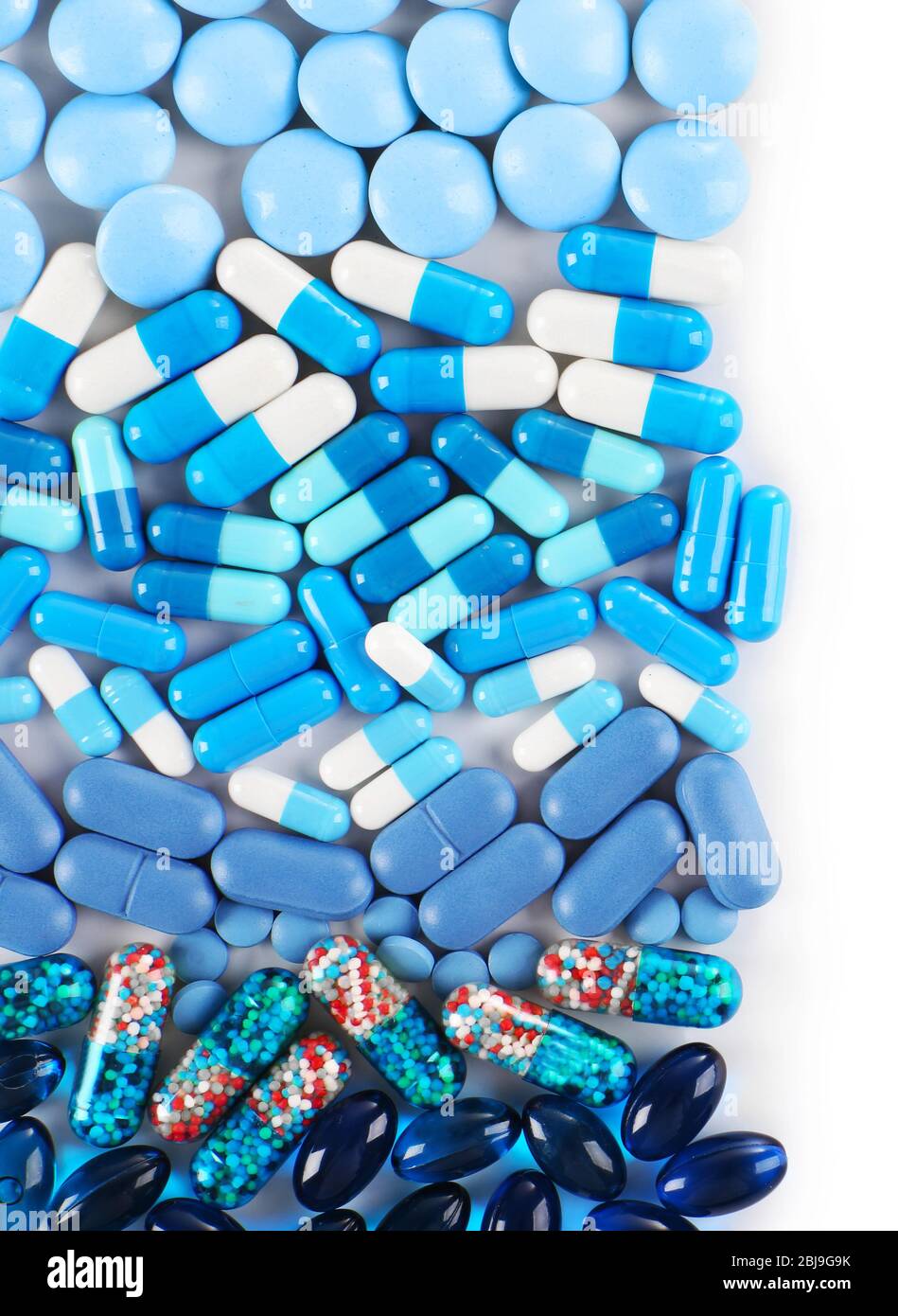 Blue pills isolated on white Stock Photo - Alamy
