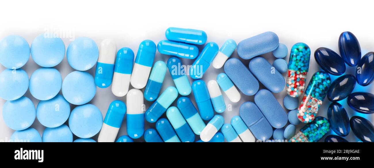 Blue pills isolated on white Stock Photo - Alamy