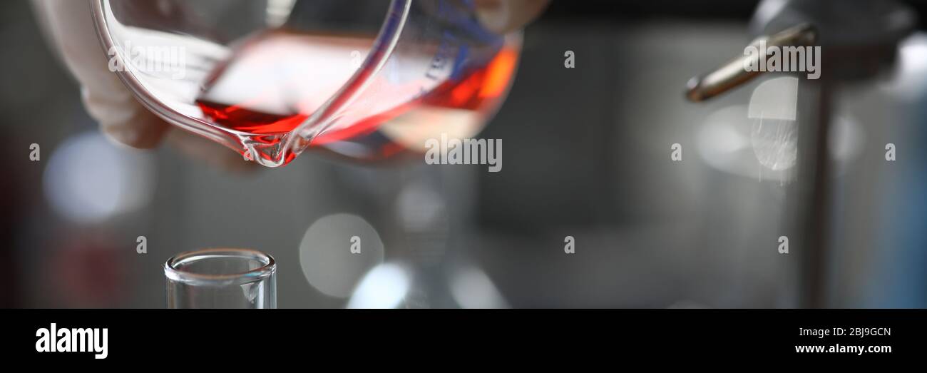 Scientist mixing reagent in test tube Stock Photo - Alamy