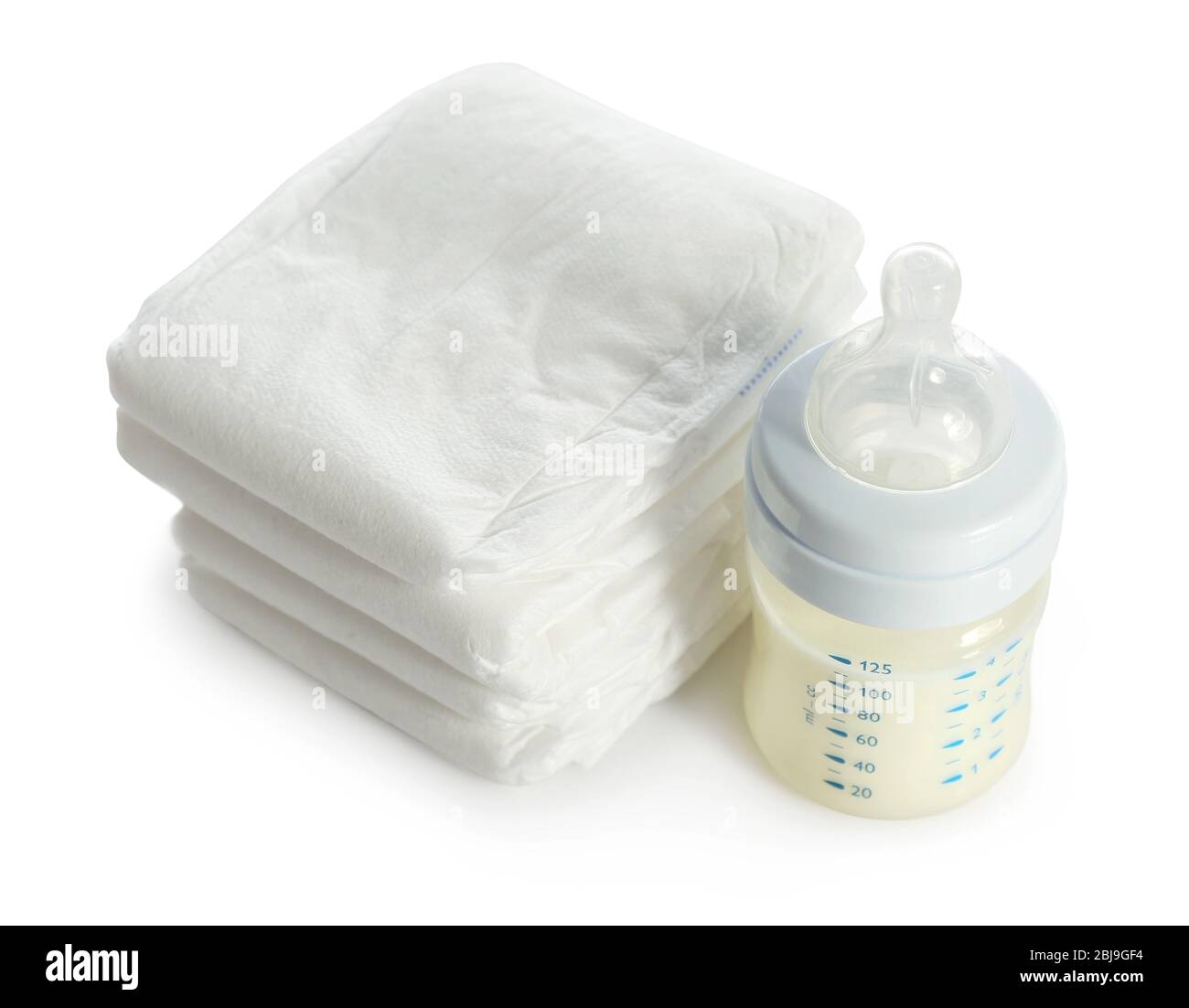 Baby bottle with milk and pile of diapers isolated on white Stock Photo ...