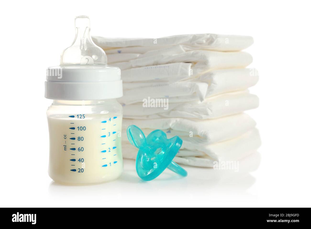 Baby bottle with milk and pile of diapers isolated on white Stock Photo ...