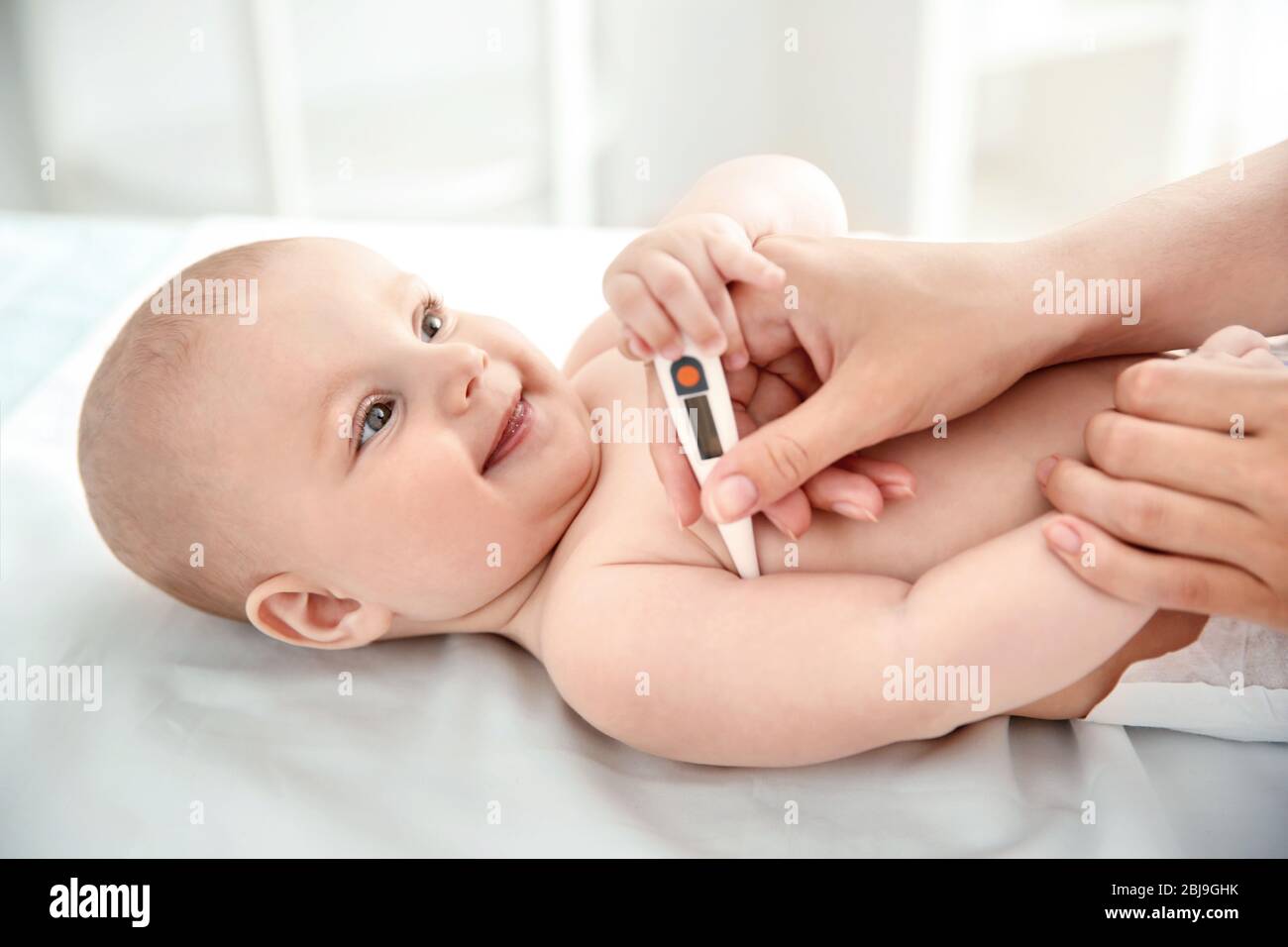 Taking temperature baby doctor hi-res stock photography and images - Alamy