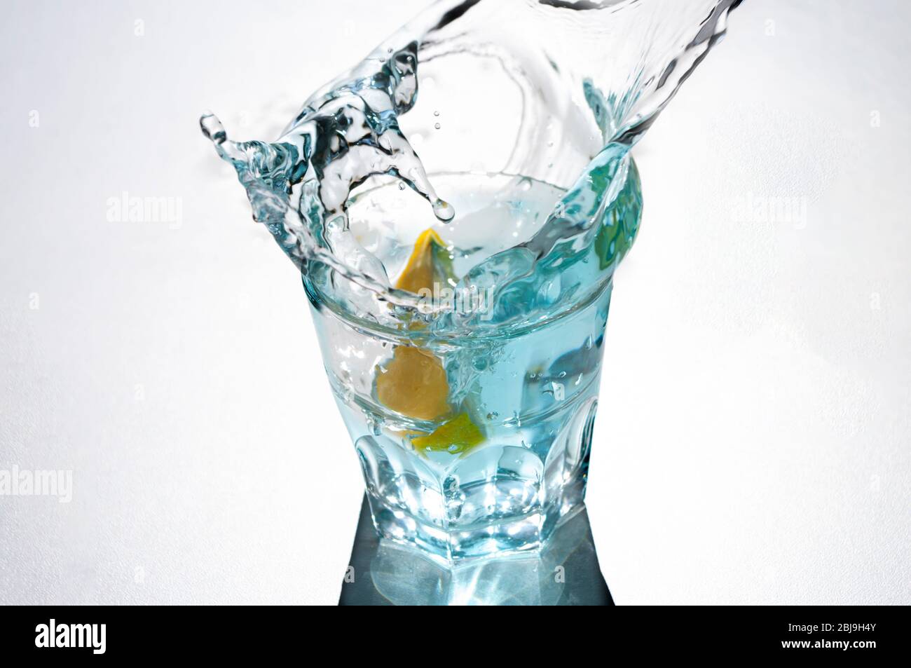 Glass of water splash, lemon inside. Fresh drink Stock Photo - Alamy