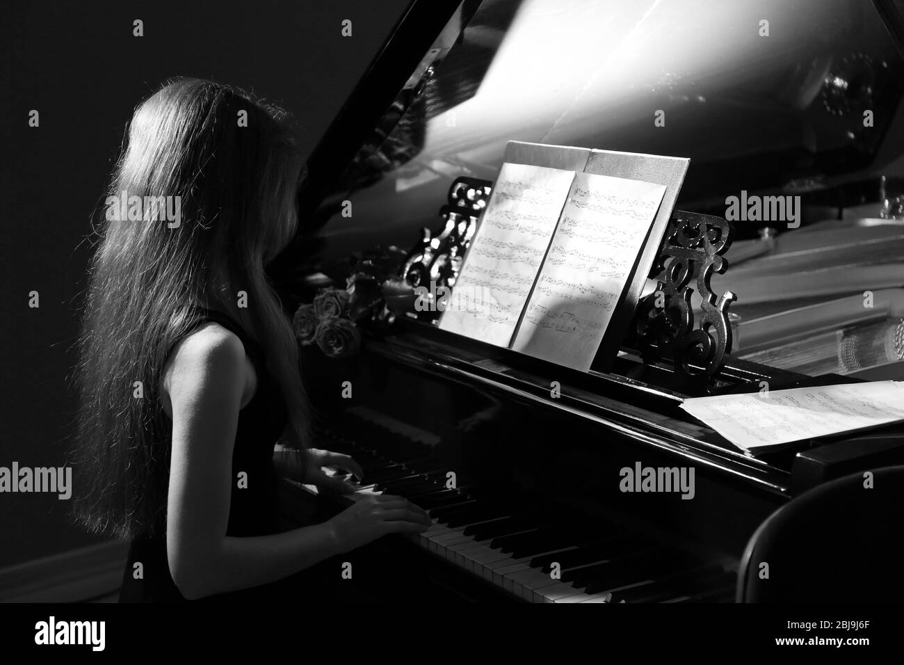 Girl playing piano Stock Photo - Alamy