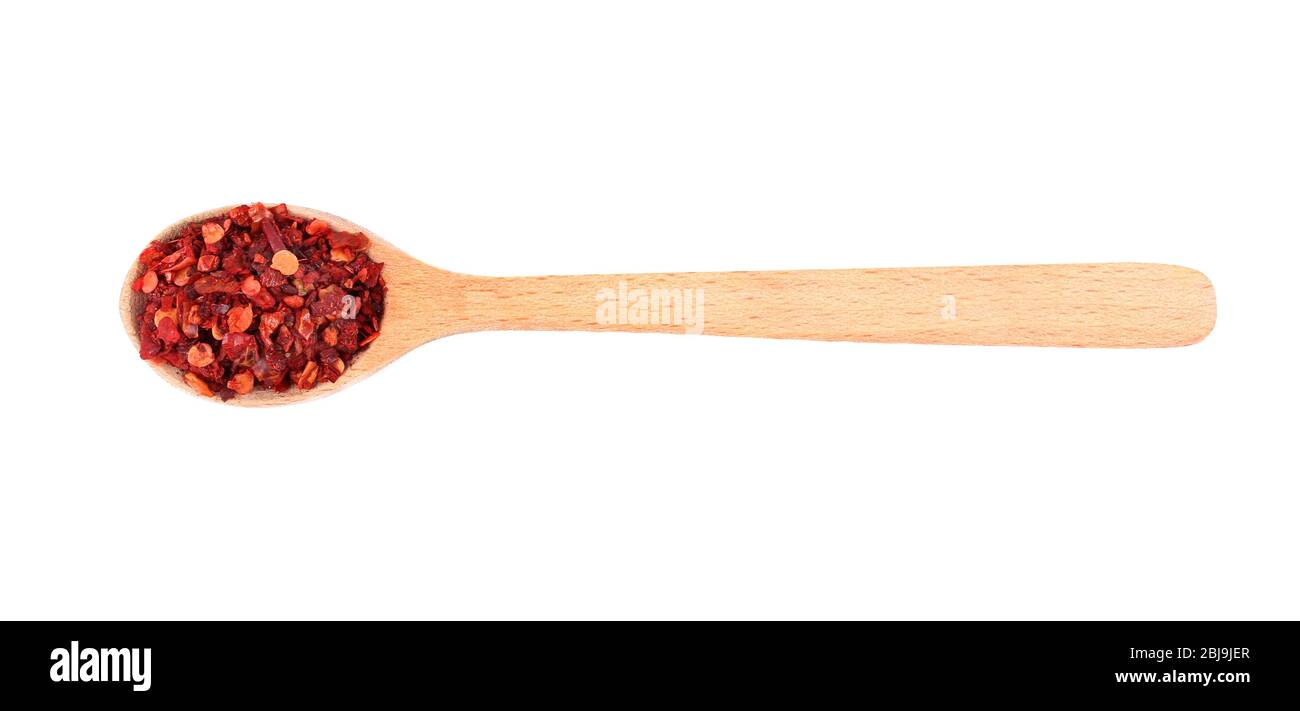 Dried chopped chili pepper in spoon on white background Stock Photo - Alamy
