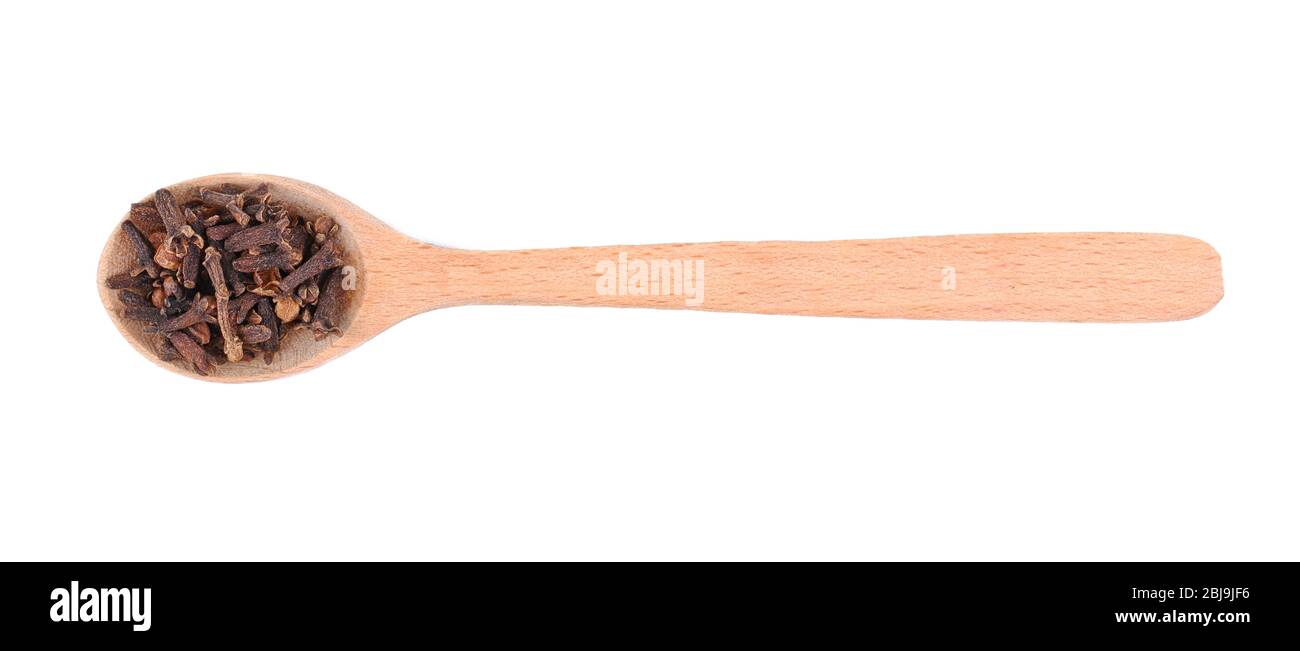 Cloves seeds in spoon on white background Stock Photo - Alamy