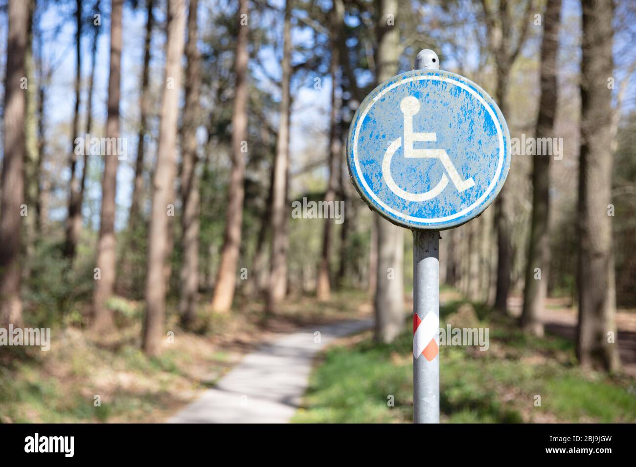 Disabled sign pointing to a wheelchair path Stock Photo - Alamy