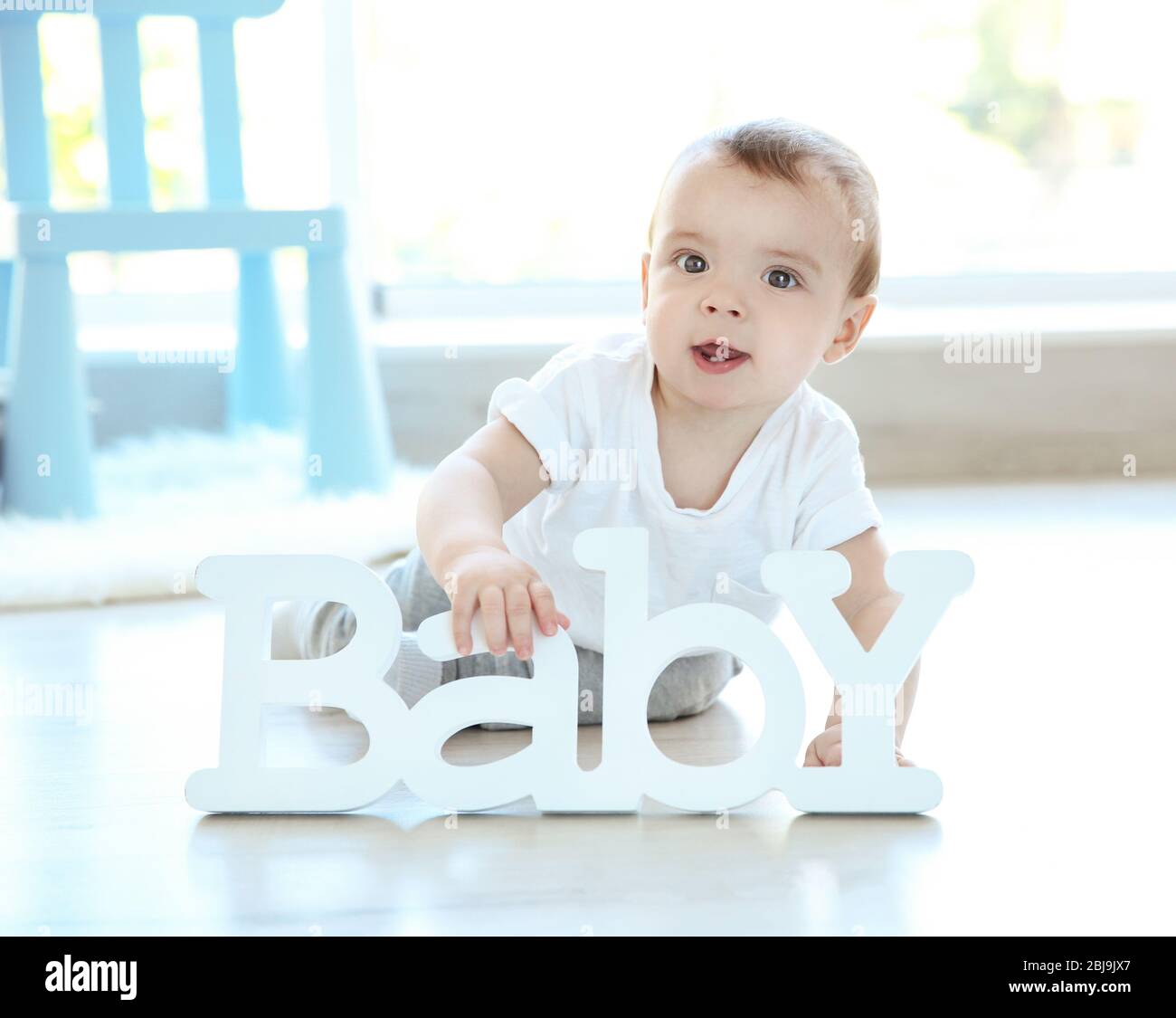 Cute baby boy with wooden word Baby Stock Photo - Alamy