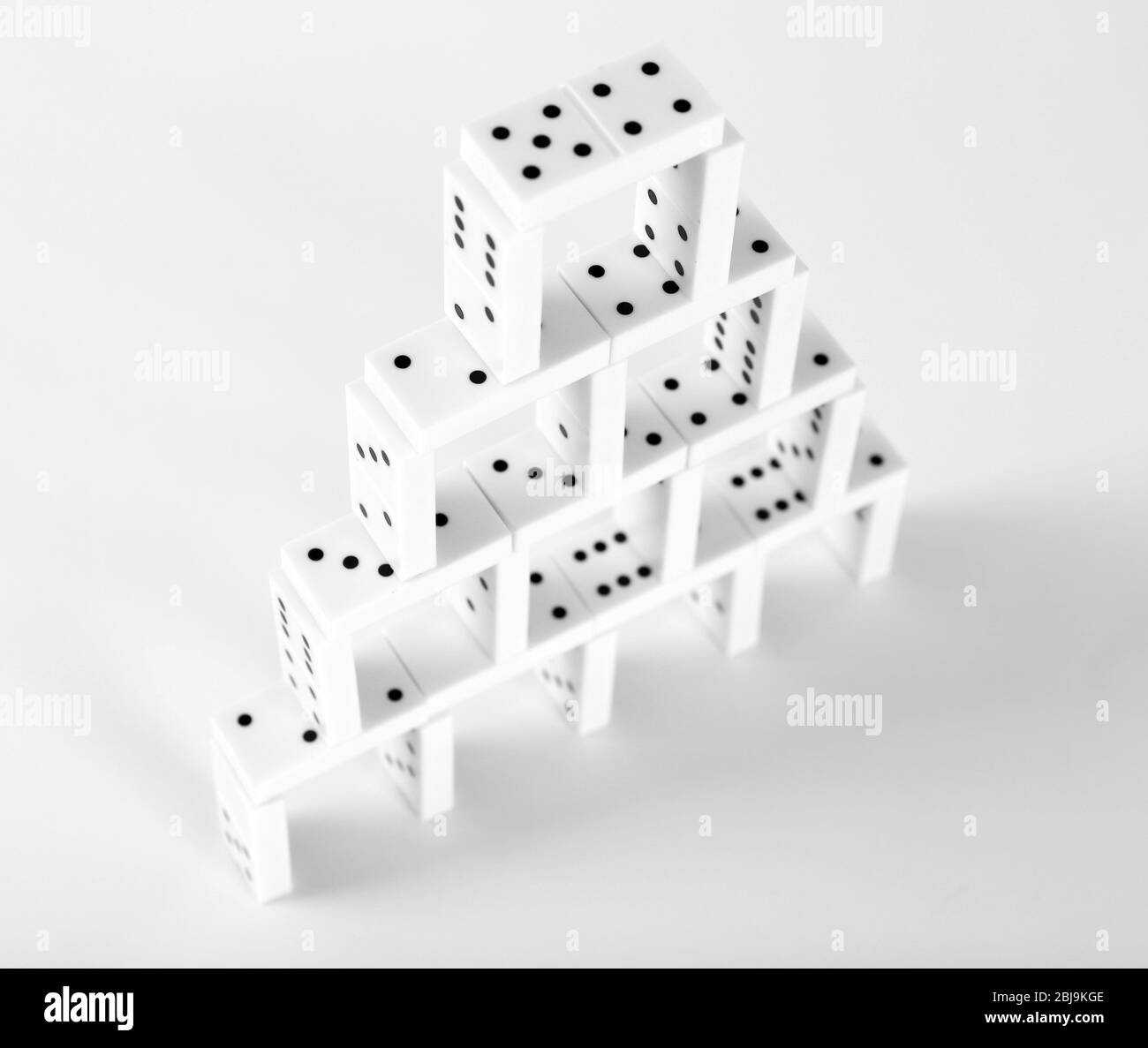Tower of dominoes, isolated on white Stock Photo - Alamy