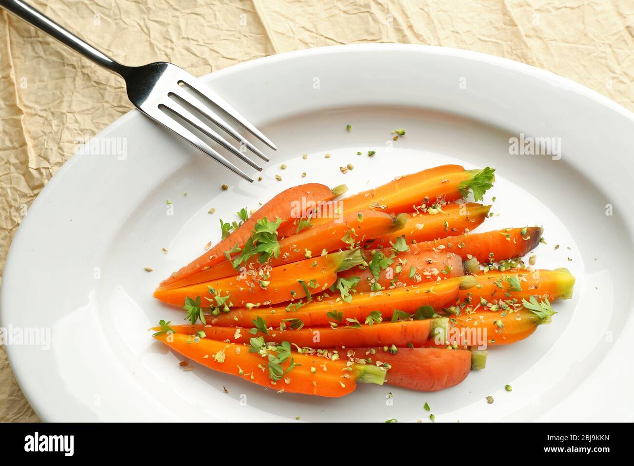Plate of sliced baby carrot with herbs closeup Stock Photo - Alamy