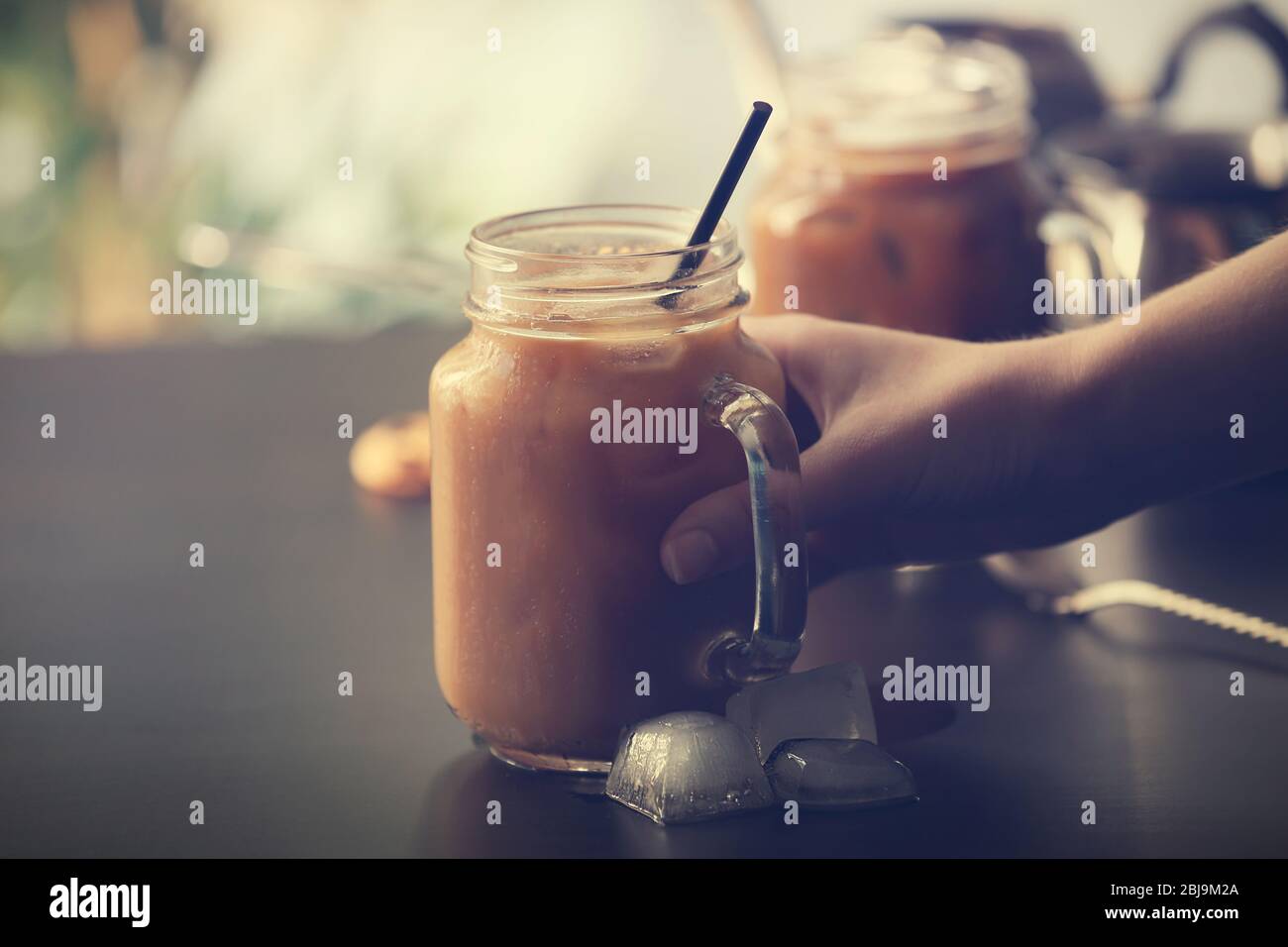Hand holding iced coffee hi-res stock photography and images - Alamy