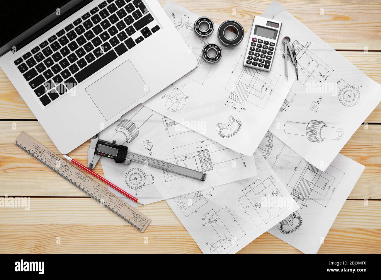 Engineering drawings of parts with tools and laptop Stock Photo - Alamy