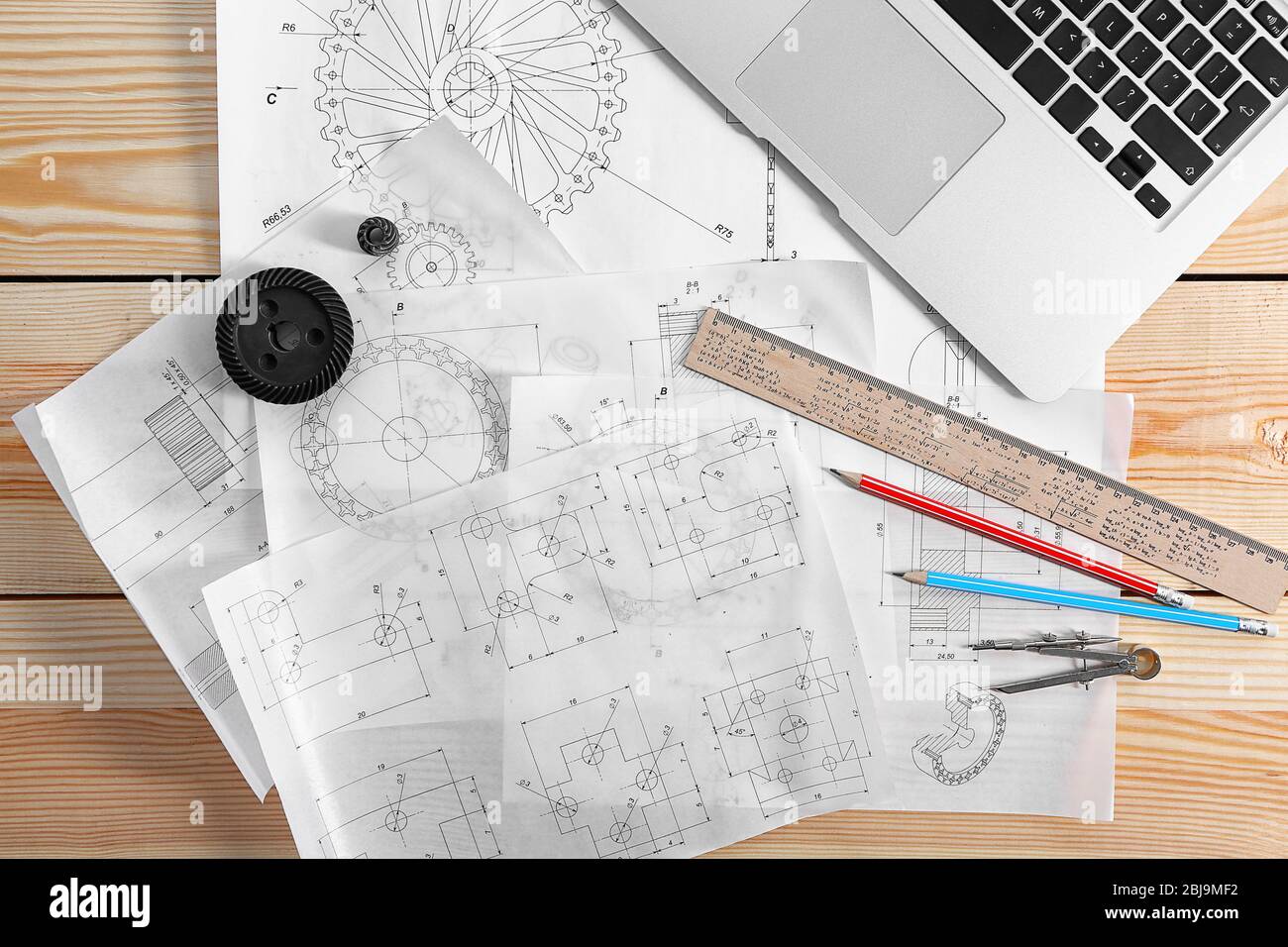 Engineering drawings of parts with tools and laptop Stock Photo - Alamy