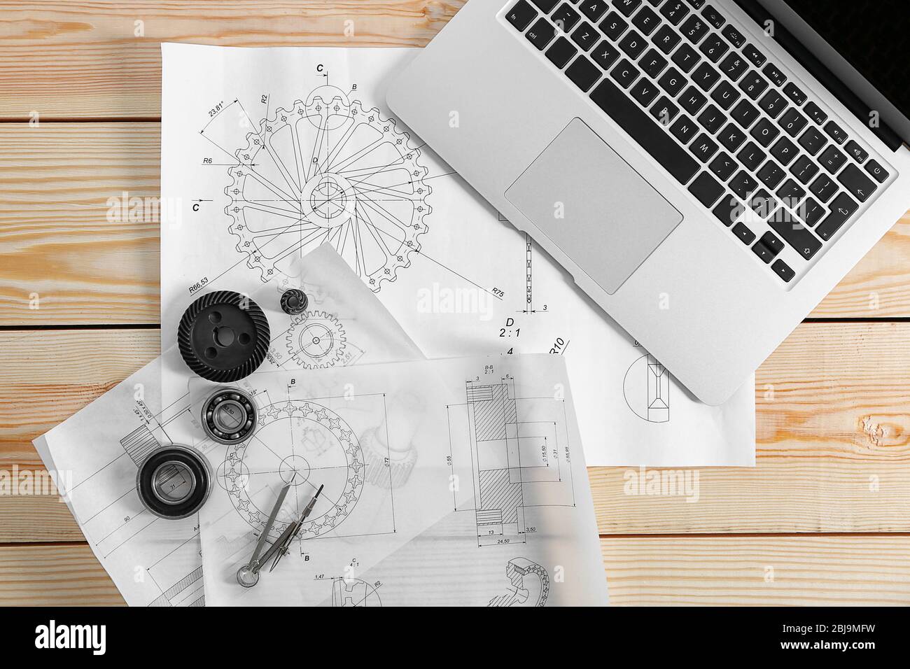 Engineering drawings of parts with tools and laptop Stock Photo - Alamy