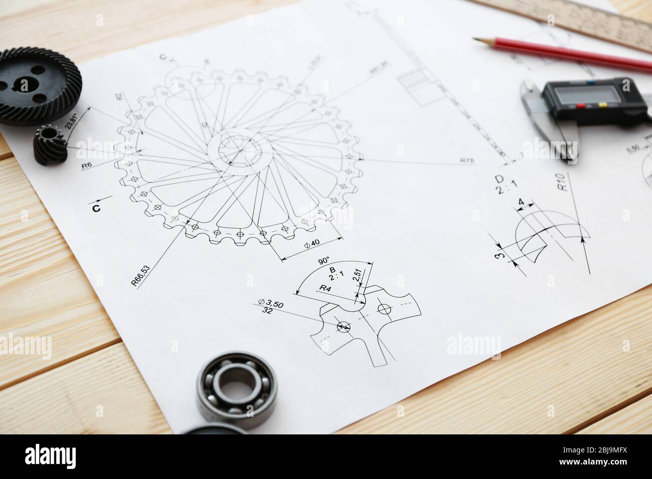 Engineering drawings of parts with tools on wooden table Stock Photo ...