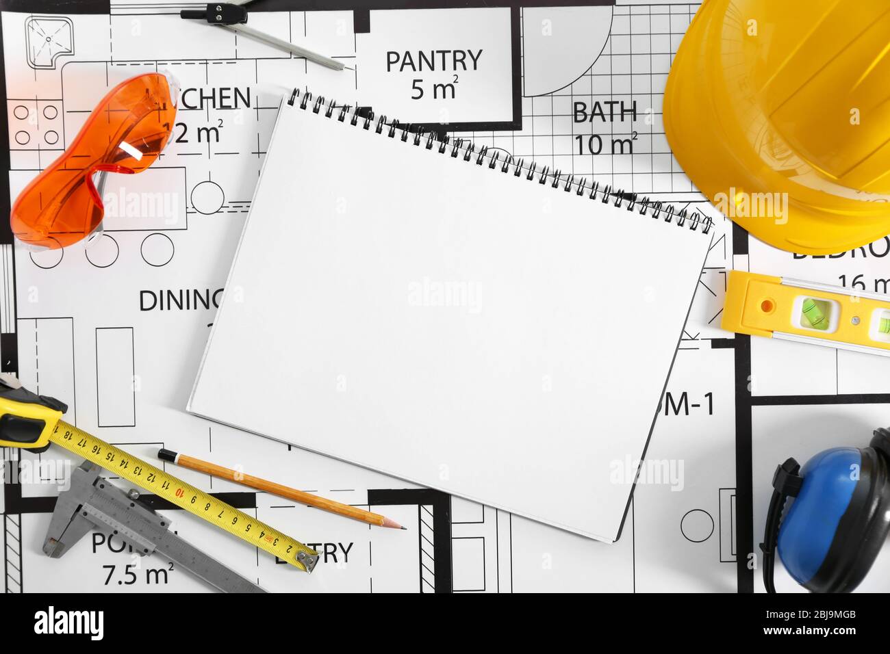 Construction blueprint with tools and notebook closeup Stock Photo - Alamy