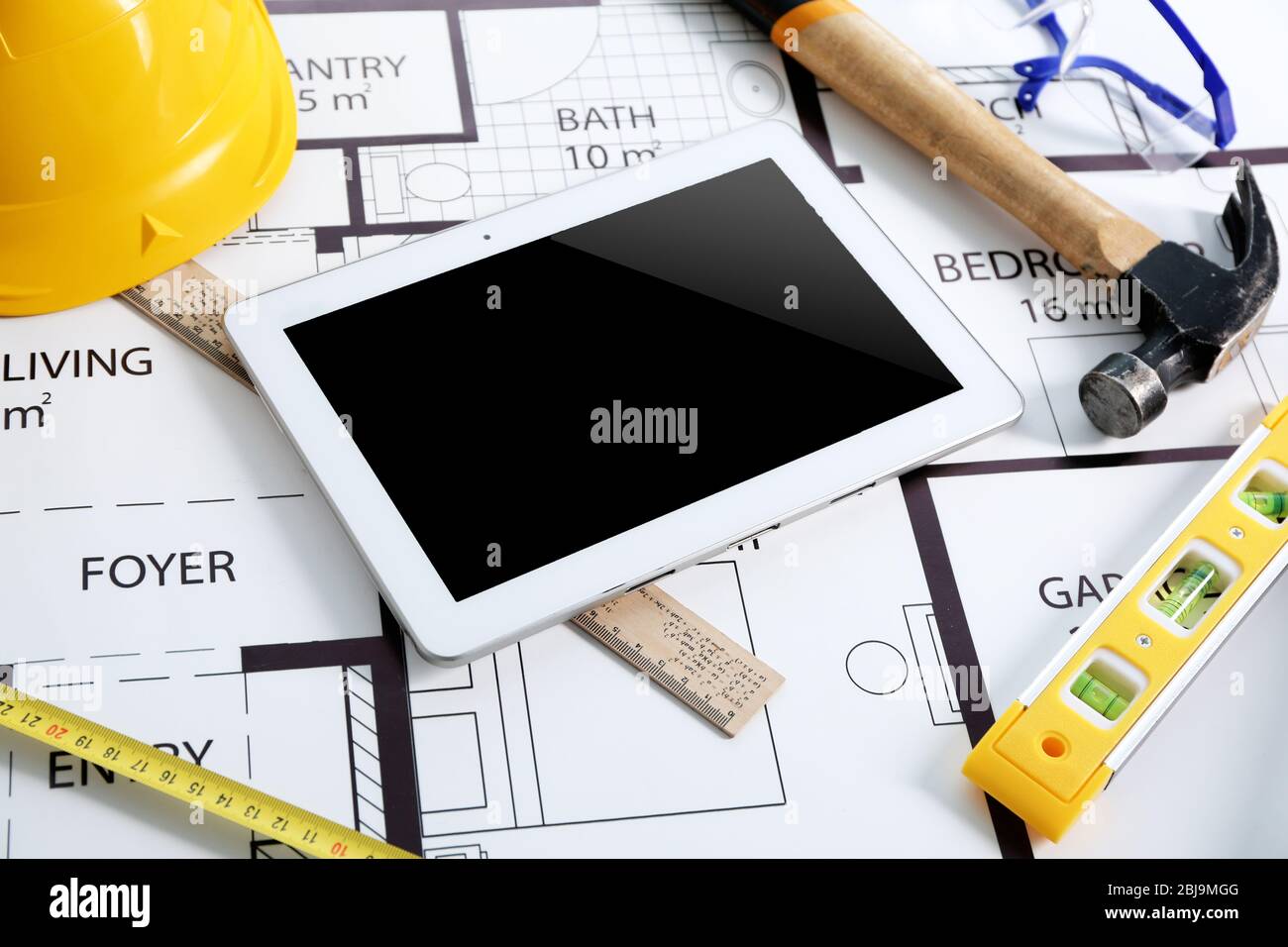 Construction drawing with tools and tablet closeup Stock Photo - Alamy