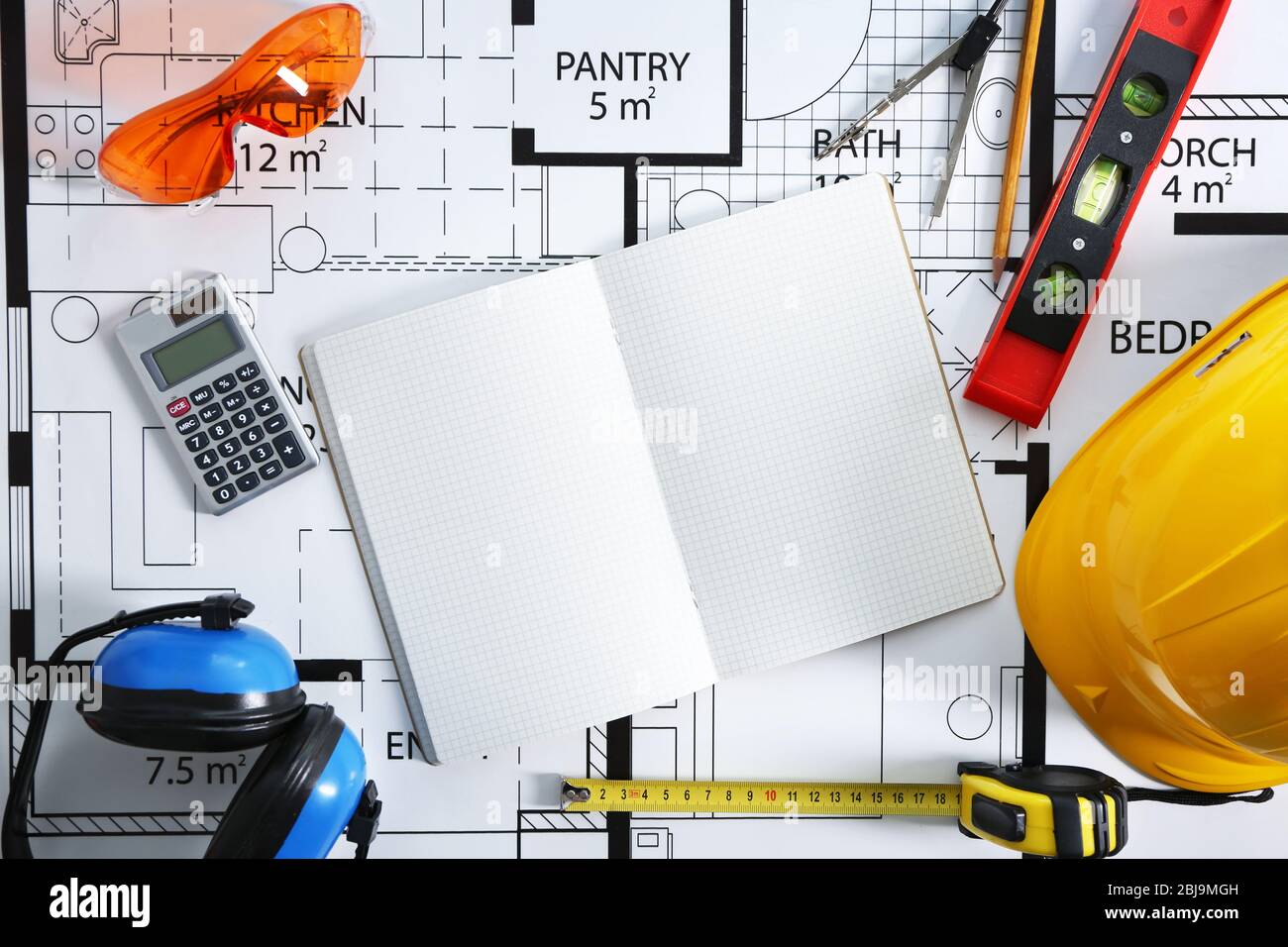Construction blueprint with tools and notebook closeup Stock Photo - Alamy