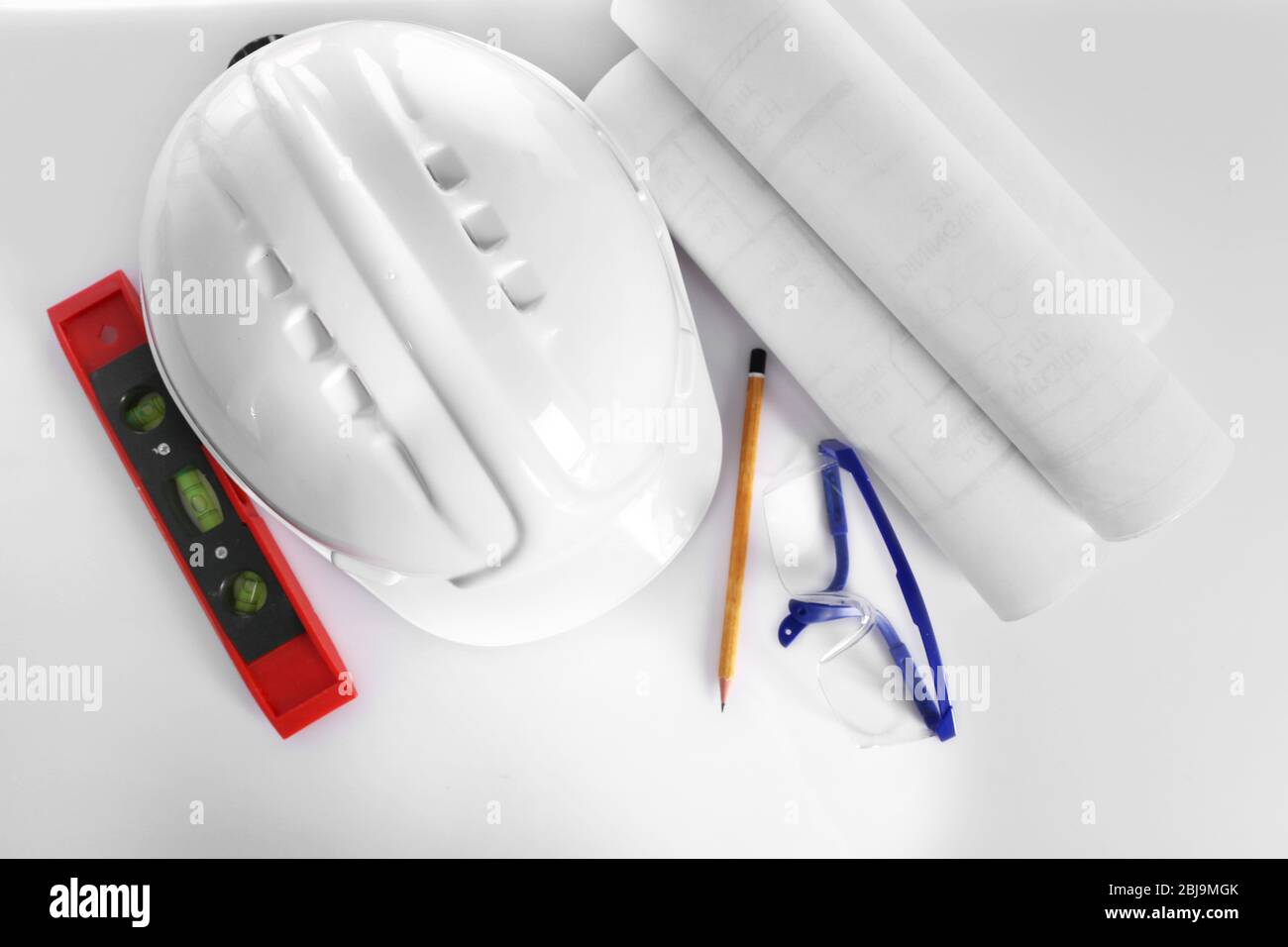 Construction drawings with tools and helmet, top view Stock Photo - Alamy
