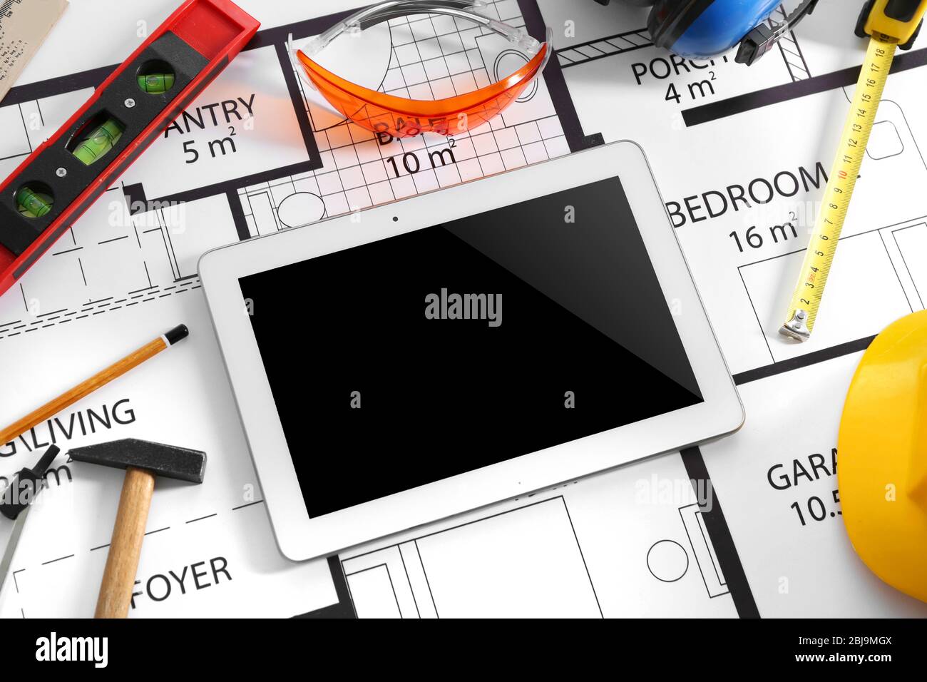 Construction drawing with tools and tablet closeup Stock Photo - Alamy