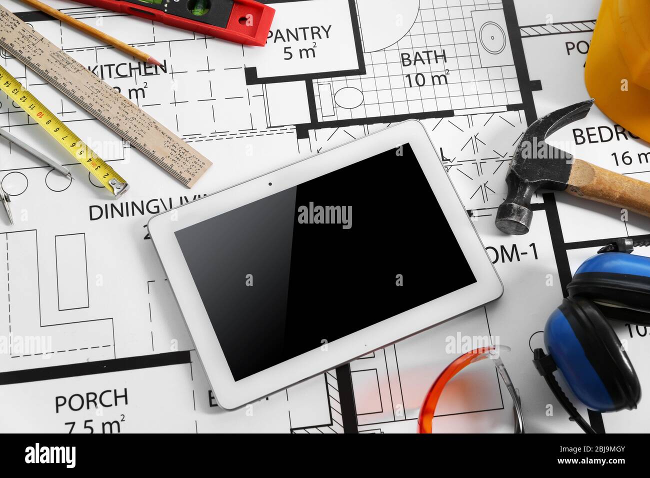 Construction drawing with tools and tablet closeup Stock Photo - Alamy