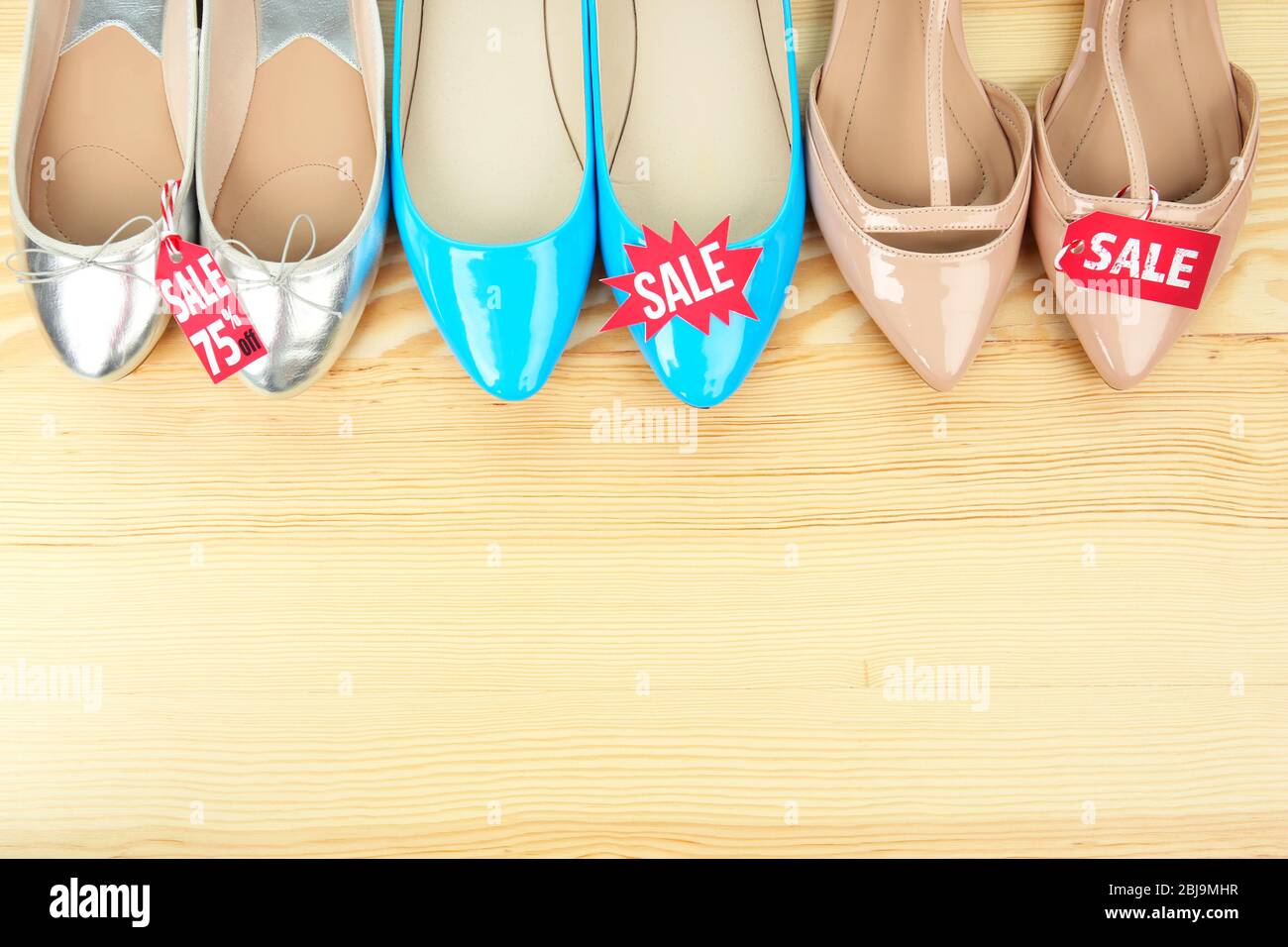 Sale concept. Set of female shoes on wooden table, flat lay Stock Photo ...