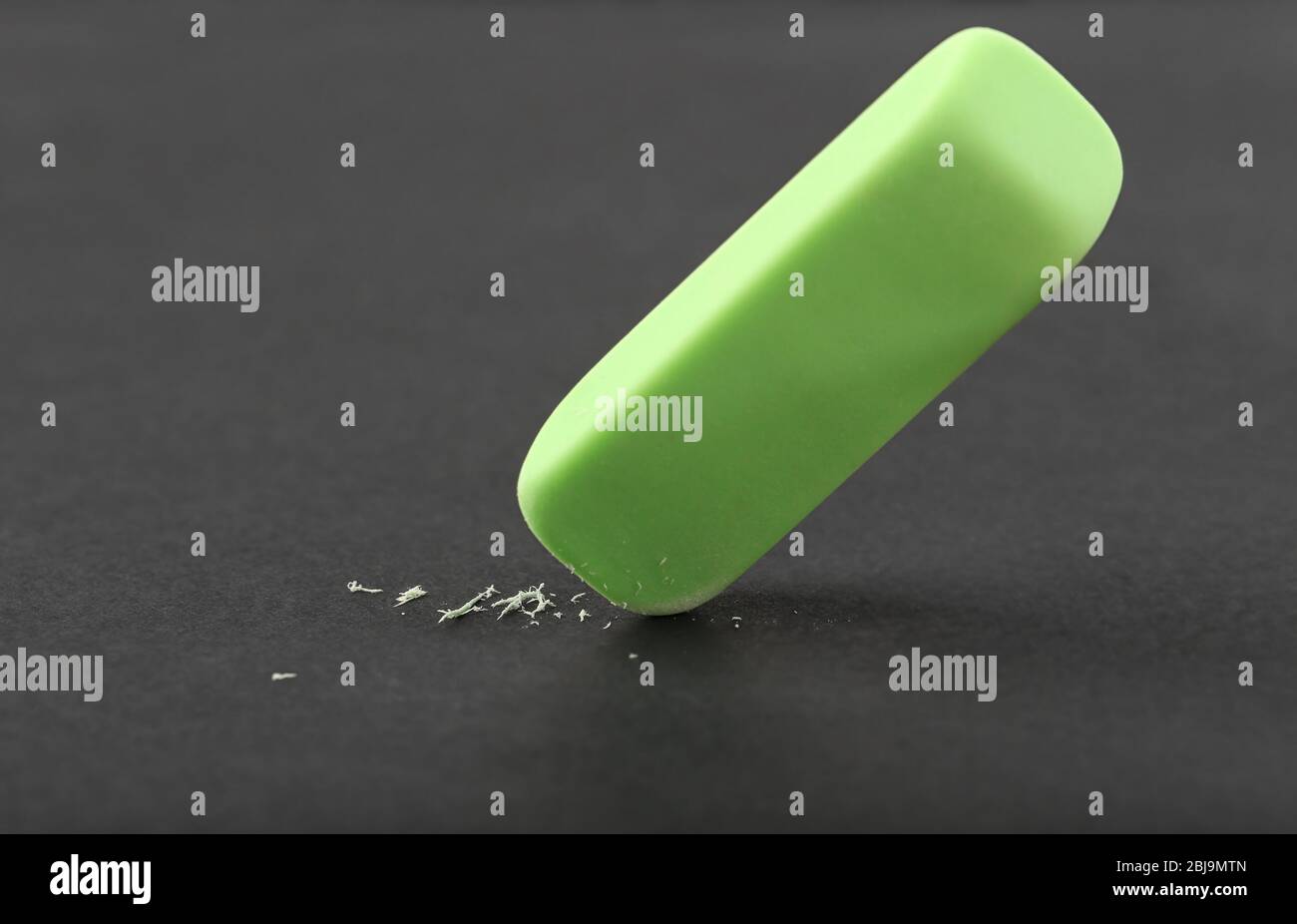 Green eraser on dark background Stock Photo - Alamy