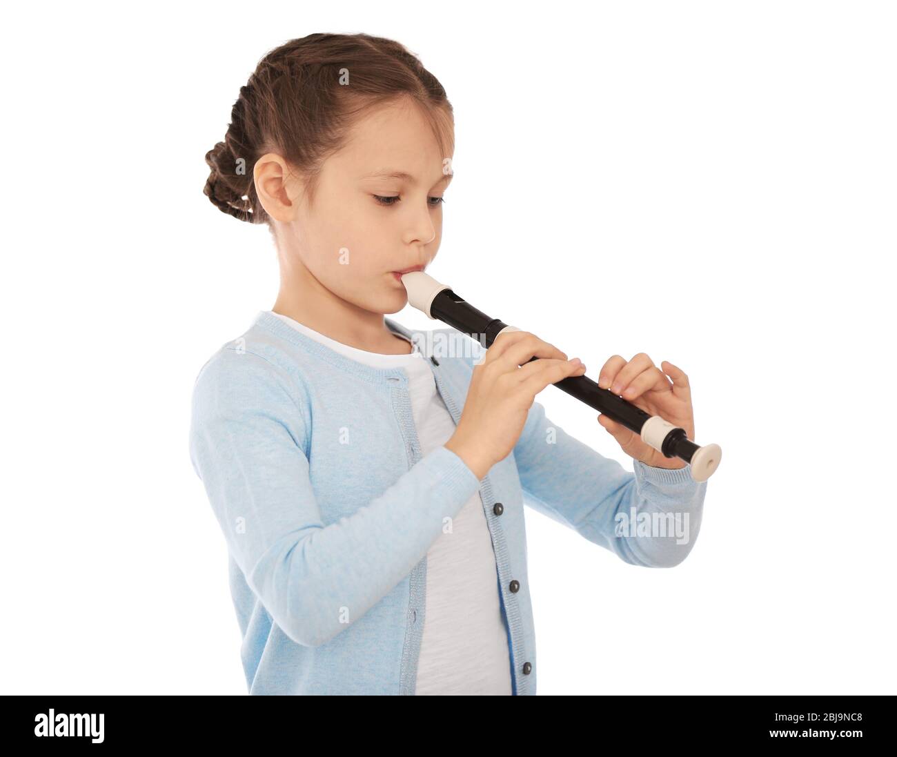 Little girl playing flute on light background Stock Photo - Alamy