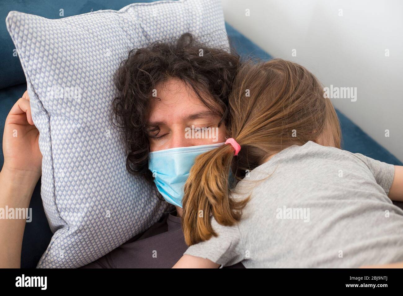 Caucasian father wearing face mask to avoid contagion sleeping with ...