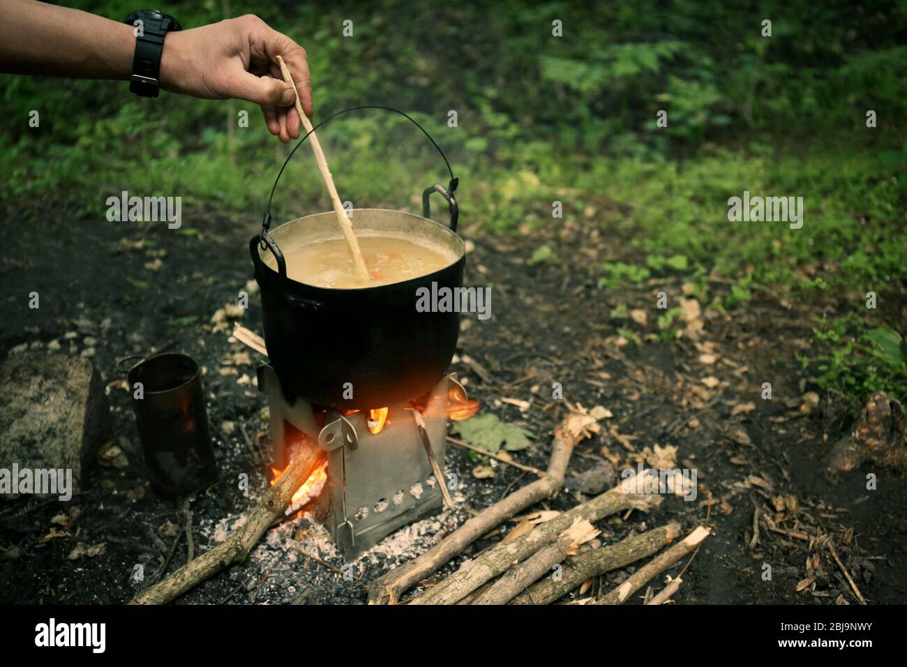 Campfire kettle in grass camp hi-res stock photography and images - Alamy