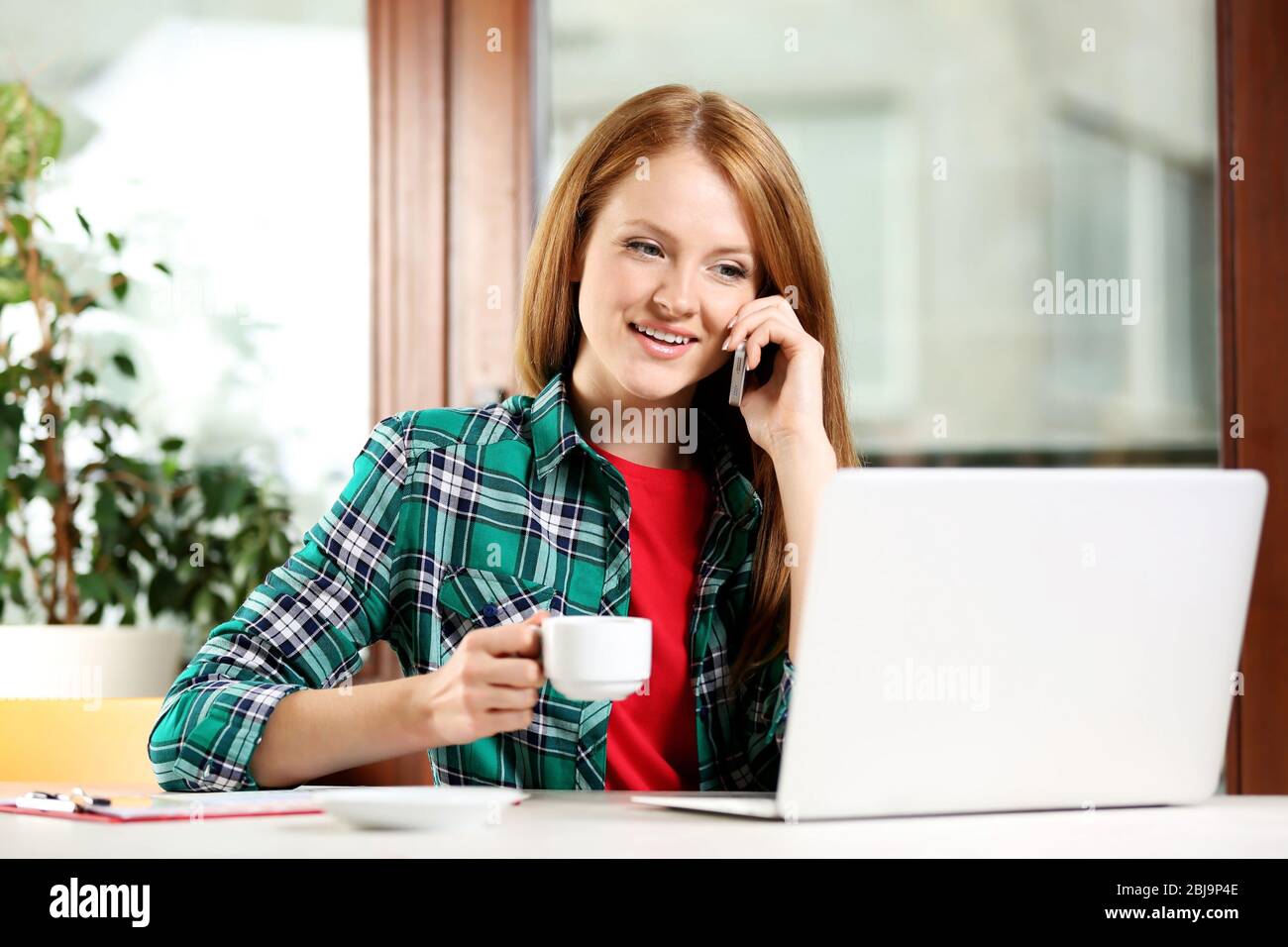 Creative girl working with laptop in office Stock Photo - Alamy