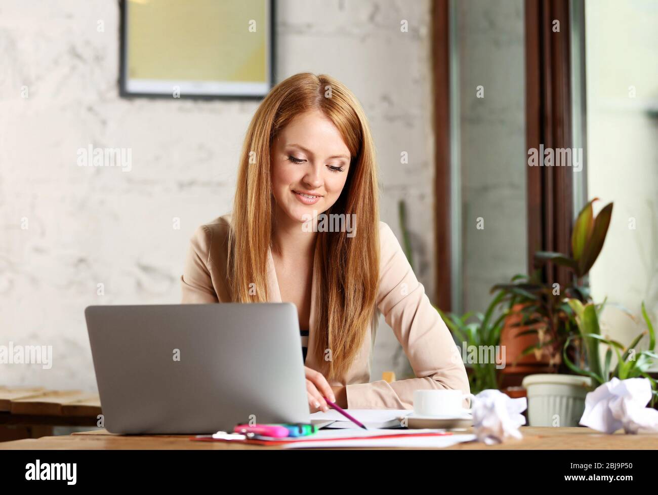 Creative girl working with laptop in office Stock Photo - Alamy