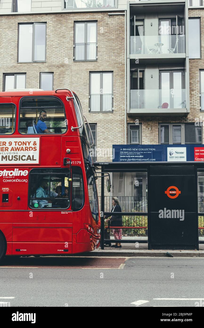 London/UK-30/7/18: people getting on a red double-decker bus at Hansel ...