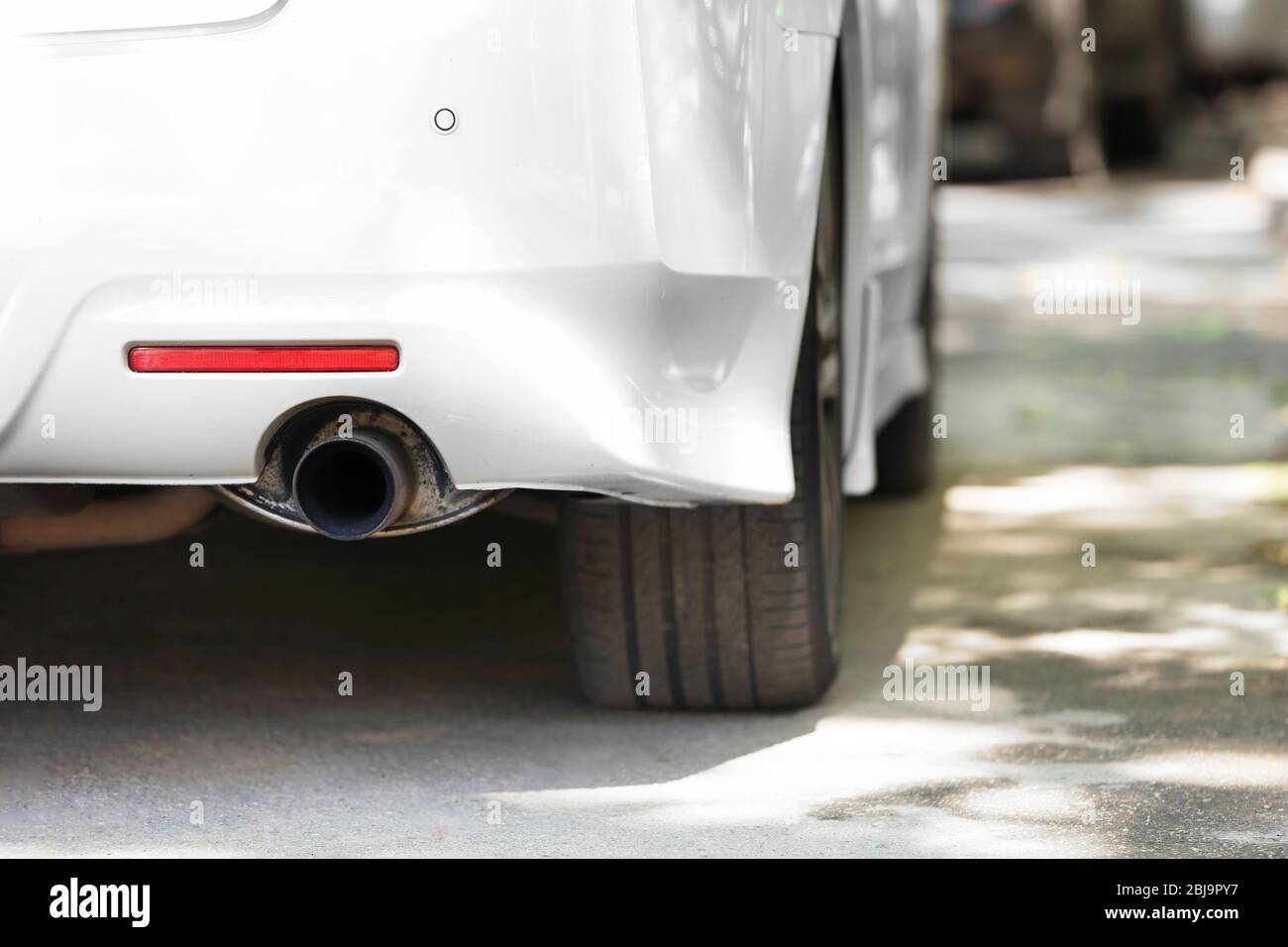 Exhaust pipe and back part of a car Stock Photo - Alamy