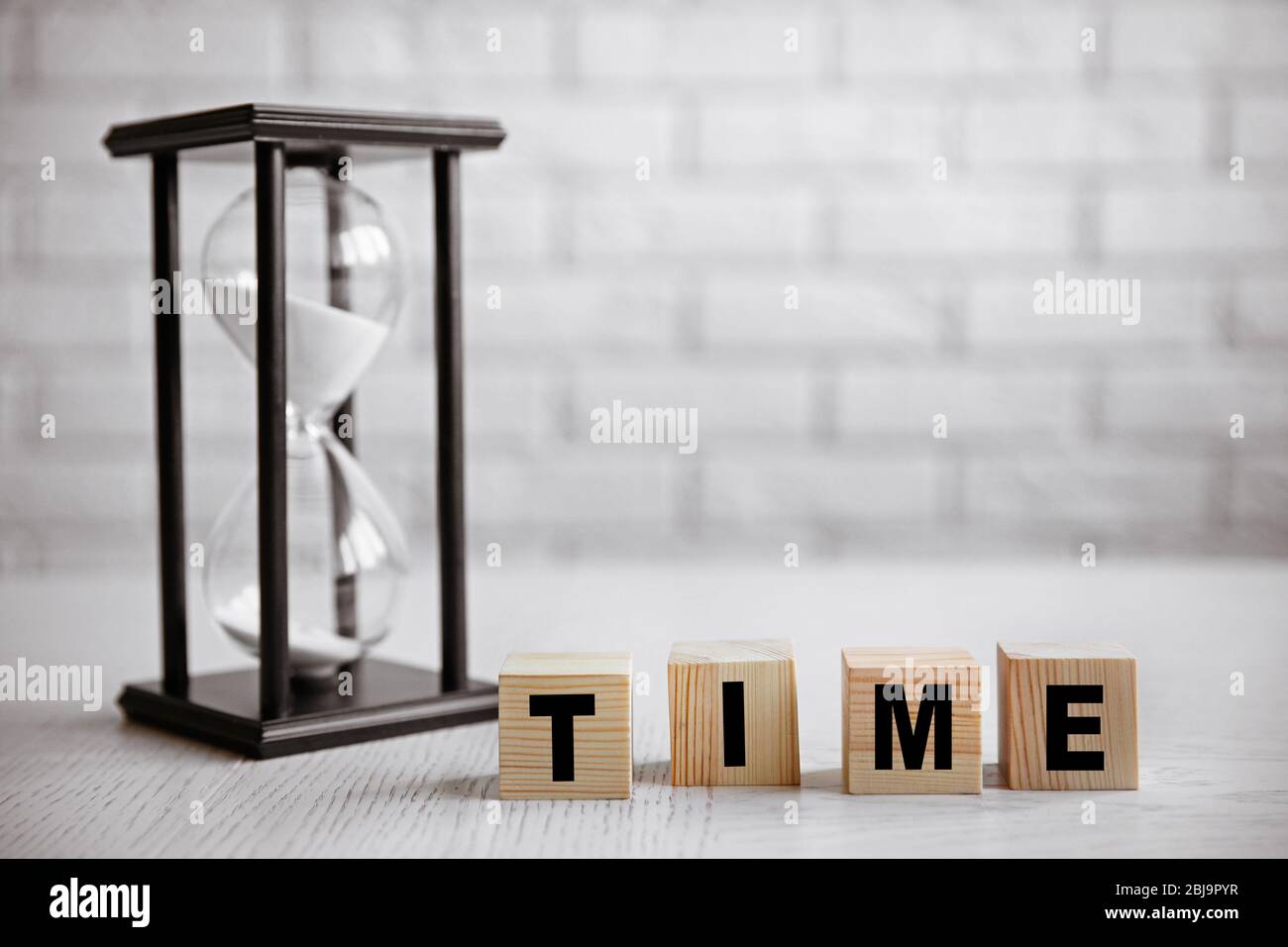 Word TIME with hourglass on white table Stock Photo - Alamy