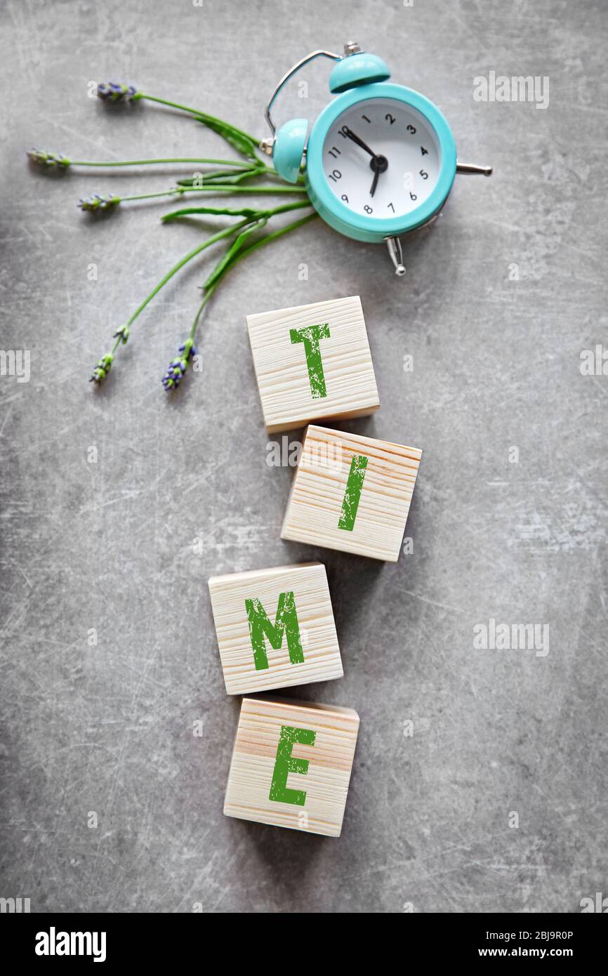 Word TIME with clock on a color background Stock Photo - Alamy