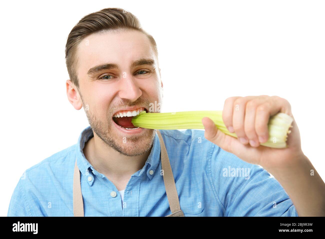 Handsome man eating celery, isolated on white Stock Photo - Alamy