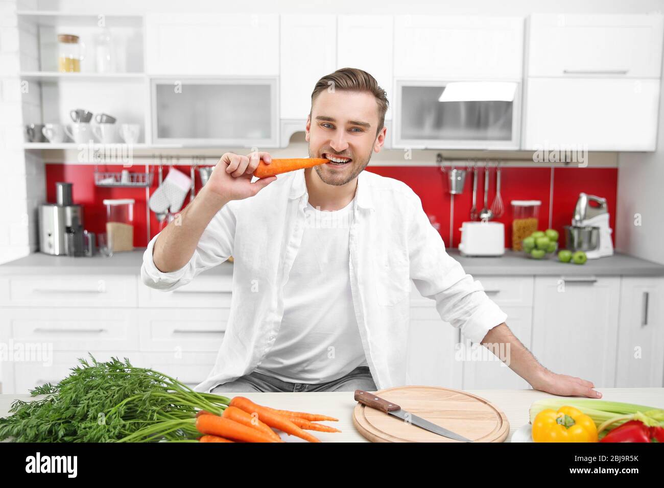 Vegan man holding carrot kitchen hi-res stock photography and images ...