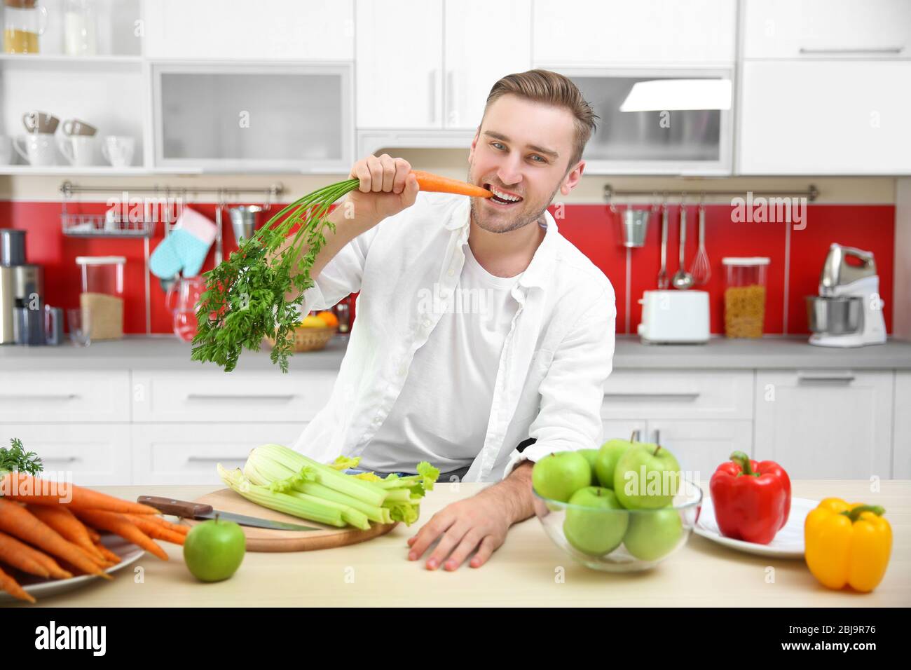 Vegan man holding carrot kitchen hi-res stock photography and images ...