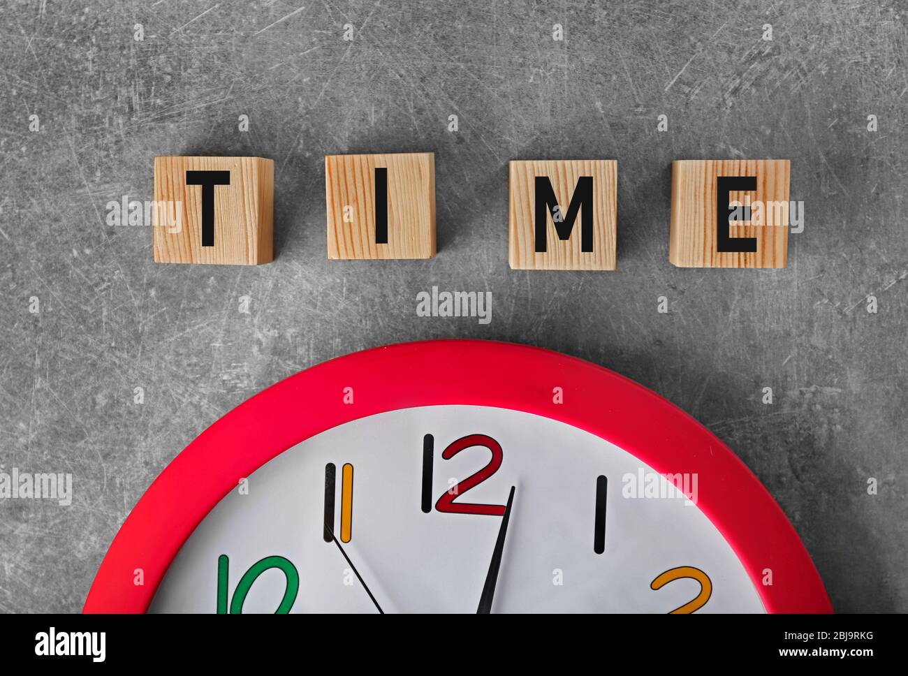 Clock and word TIME on grey background Stock Photo - Alamy