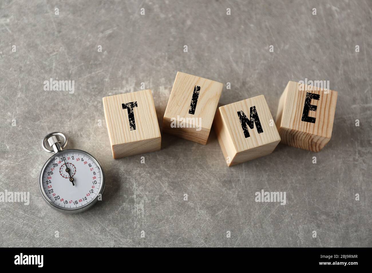 Stopwatch and word TIME on grey background Stock Photo - Alamy