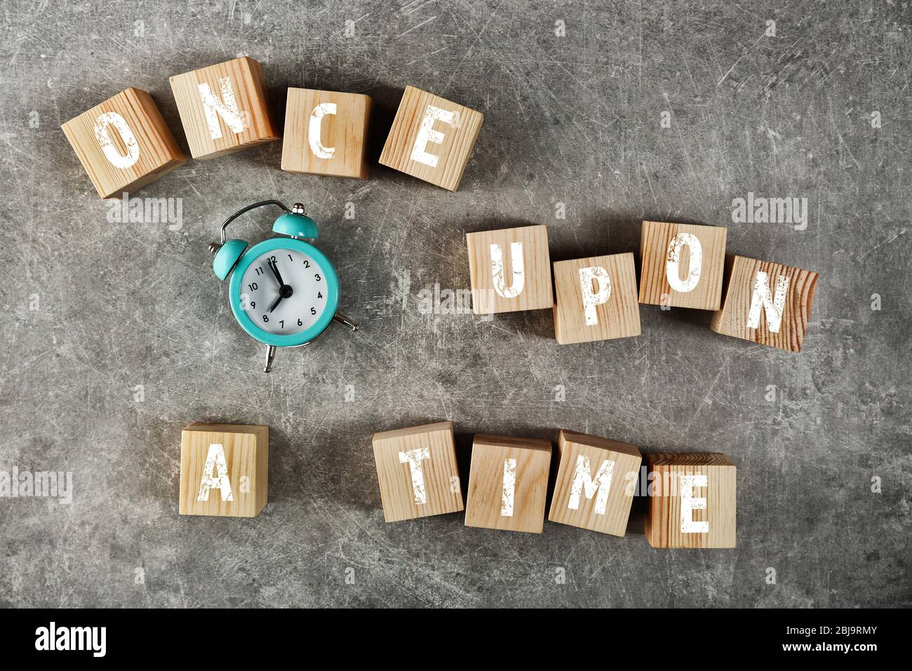 Clock and words ONCE UPON A TIME on grey background Stock Photo - Alamy