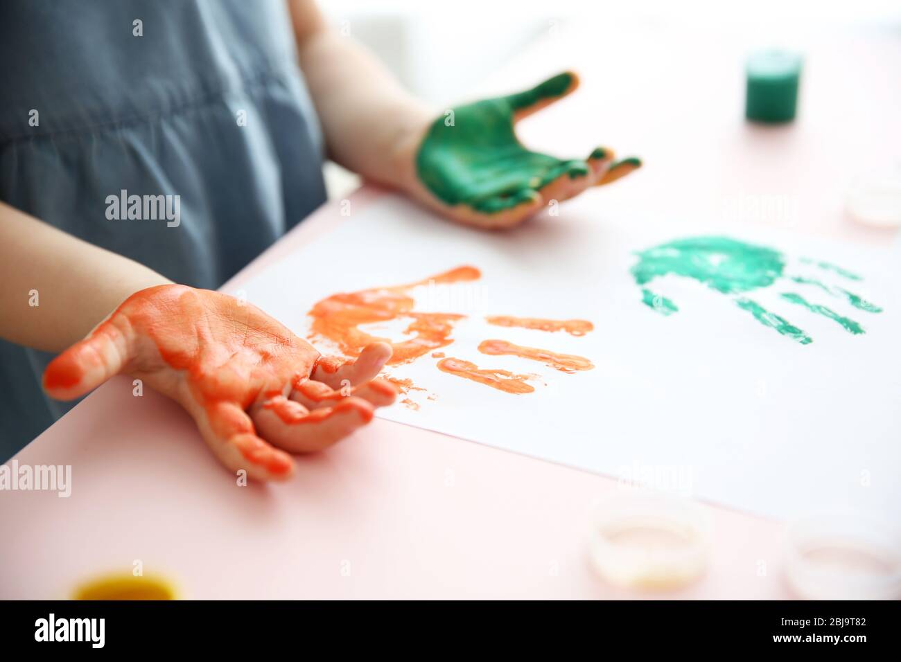 Child making hand prints on paper Stock Photo - Alamy