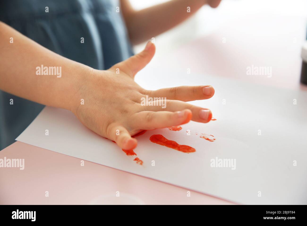 Child making hand print on paper Stock Photo - Alamy
