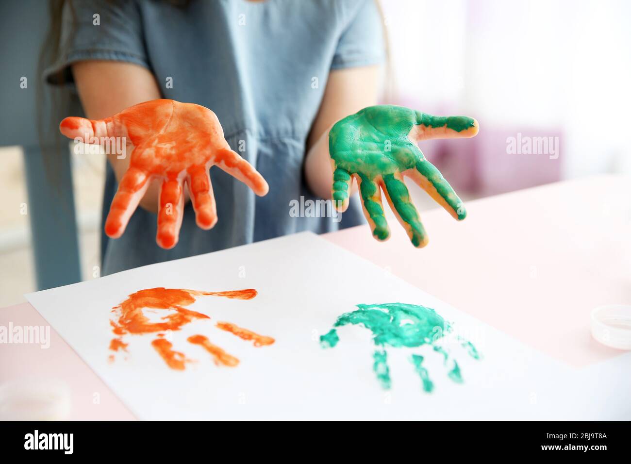 Child making hand prints on paper Stock Photo - Alamy