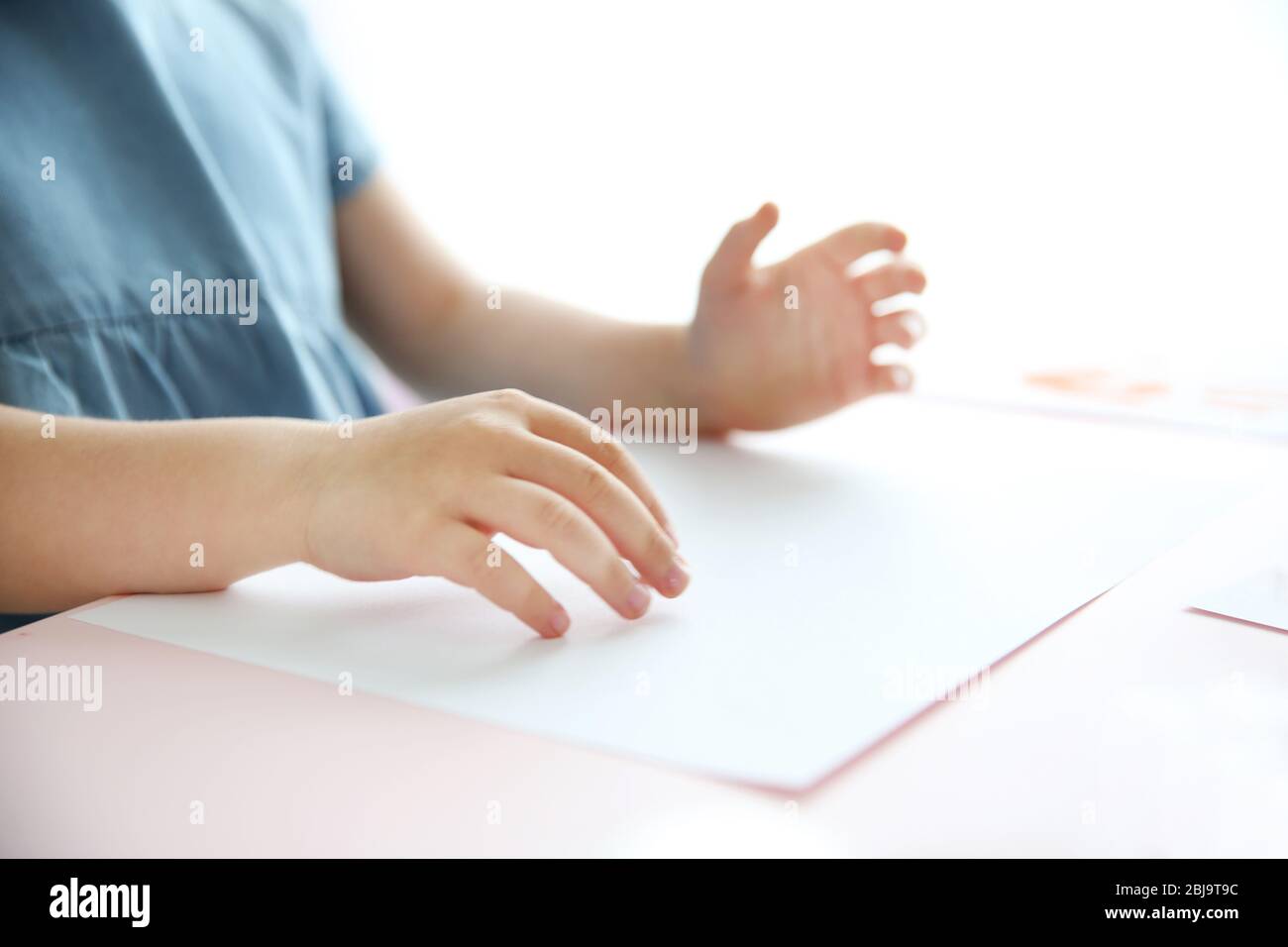 Child making hand print on paper Stock Photo - Alamy