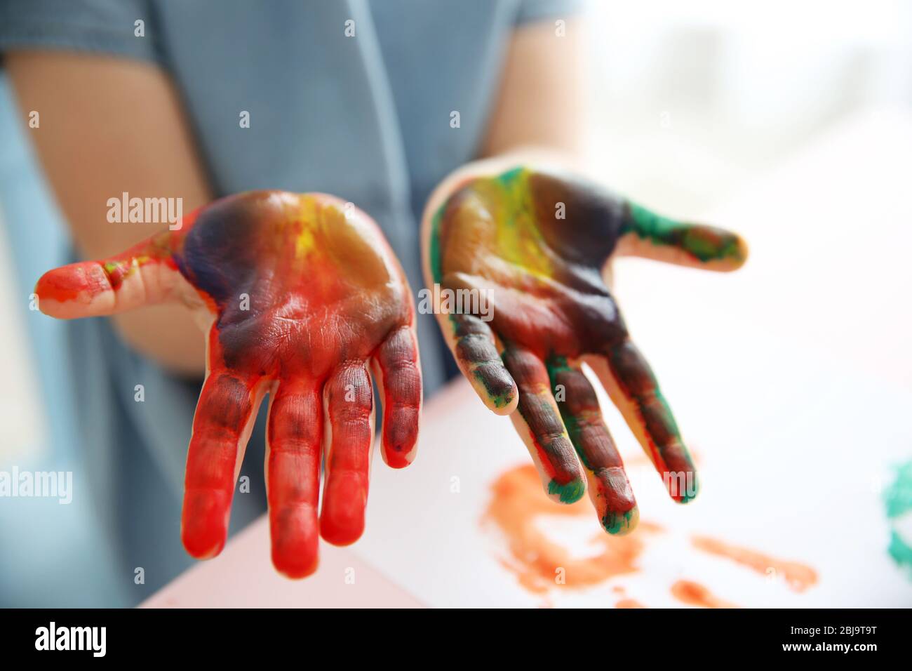 Child making hand prints on paper Stock Photo - Alamy