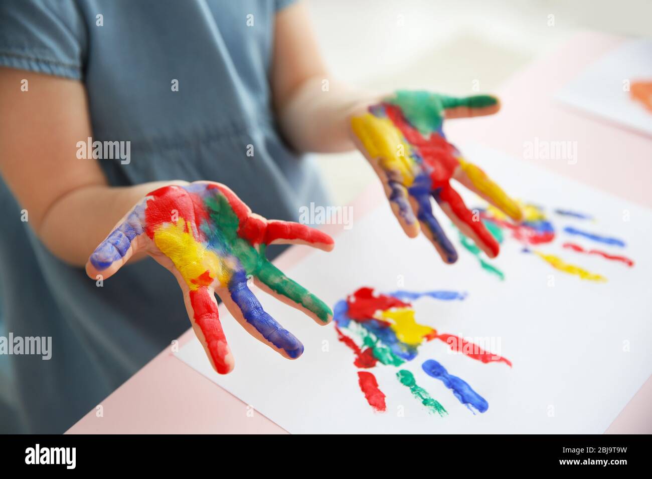 Child making hand prints on paper Stock Photo - Alamy
