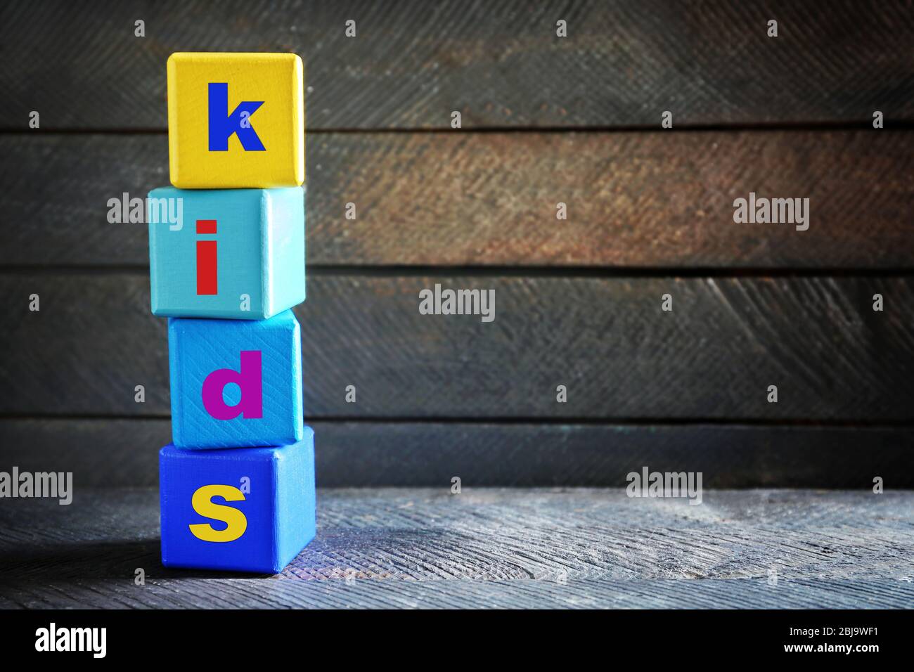 Color word KIDS on wooden background Stock Photo - Alamy