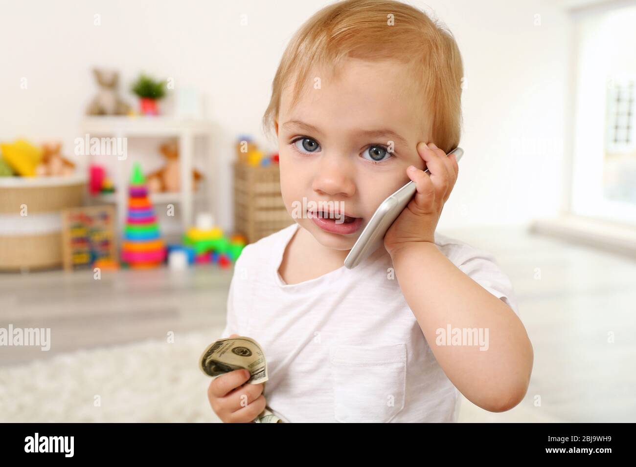 Cute baby girl playing with a smartphone Stock Photo - Alamy